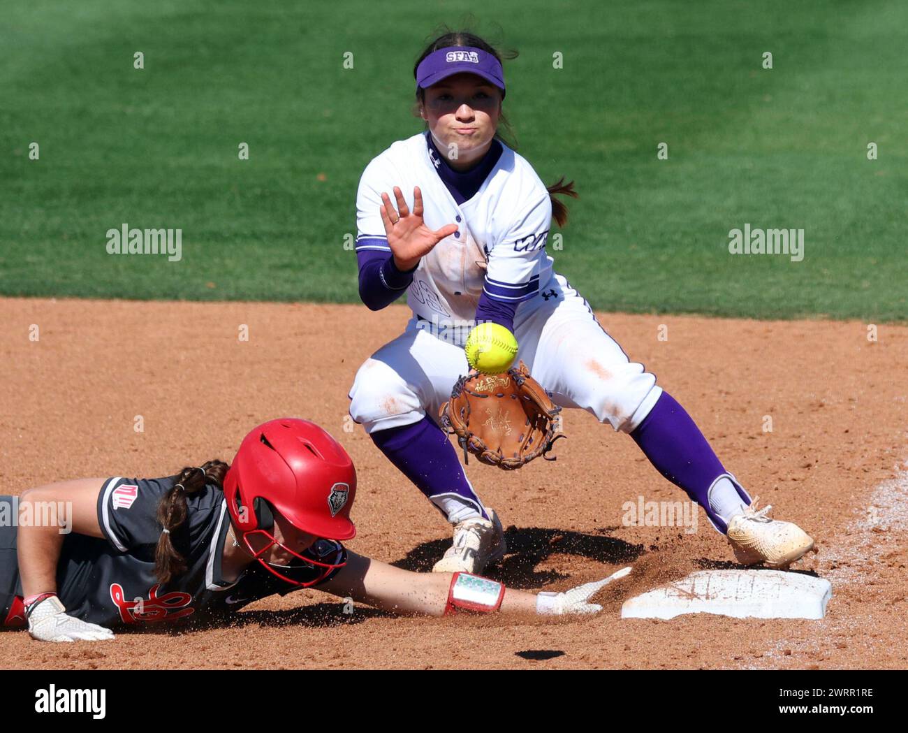 New Mexico's Hayden Luderer (27) dives back to first ahead of the ...