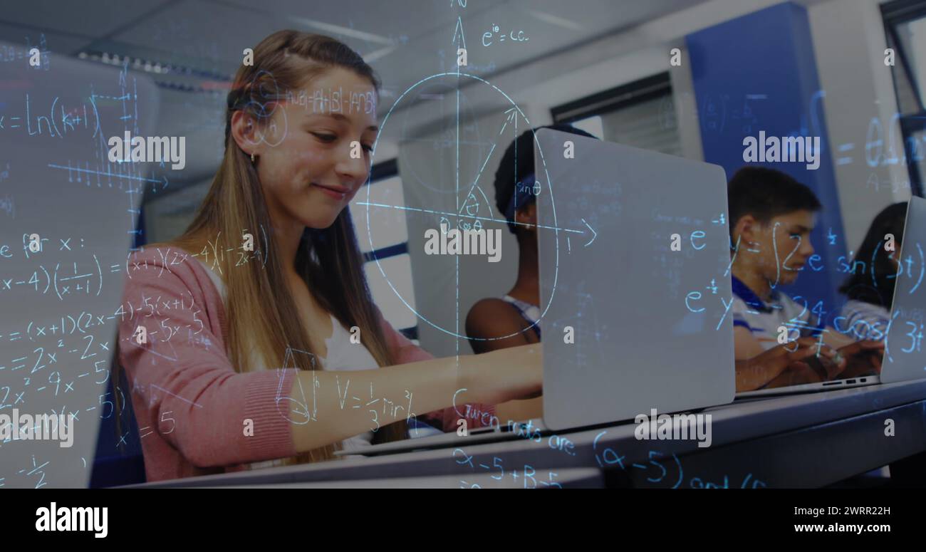 Image of mathematical equations over schoolchildren using laptop ...