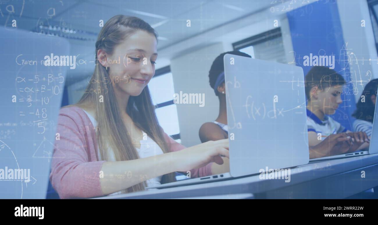 Image of mathematical equations over schoolchildren using laptop Stock ...