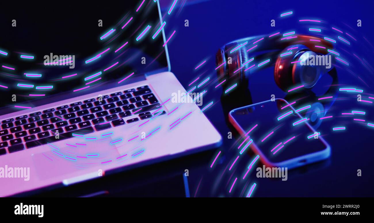 Image of neon light trails over image game computer equipment Stock ...