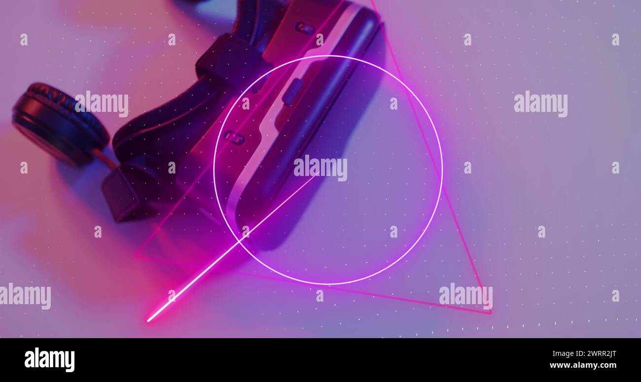 Image of neon shapes over image game computer pads Stock Photo - Alamy