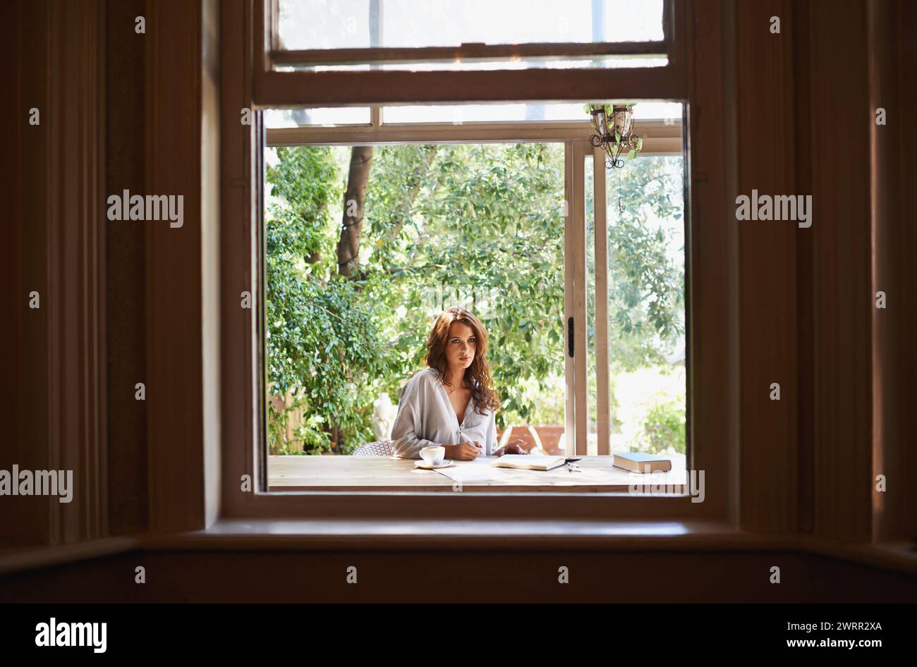 Window, nature and woman person journaling in home, porch or sun room ...