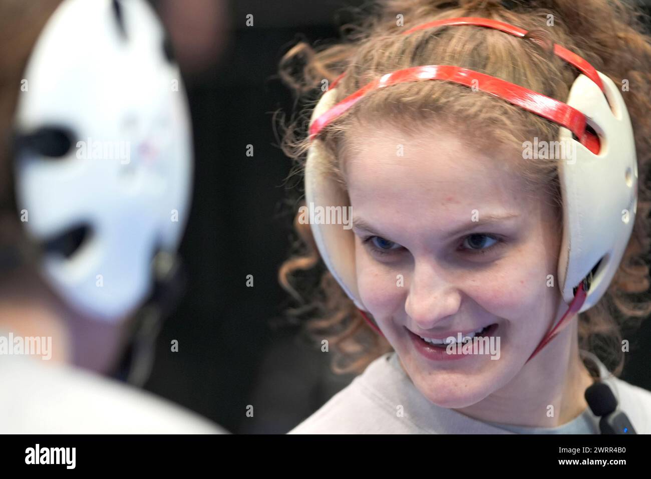North Central women's wrestling team's Kendra Ryan smiles at Sydney Petzinger during a practice ...