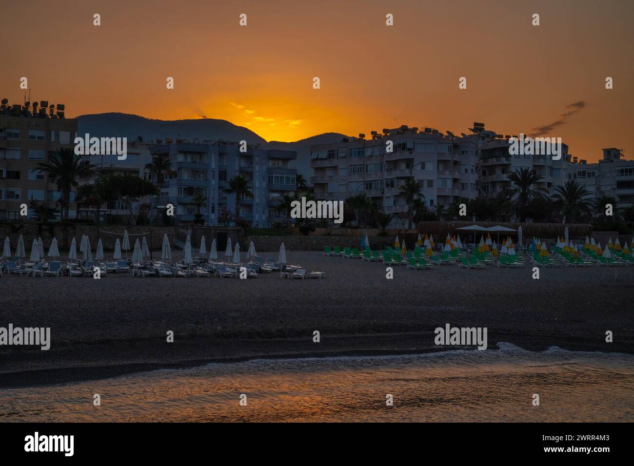 Beautiful sunrise scene on Alanya beach with view to famous Alanya ...