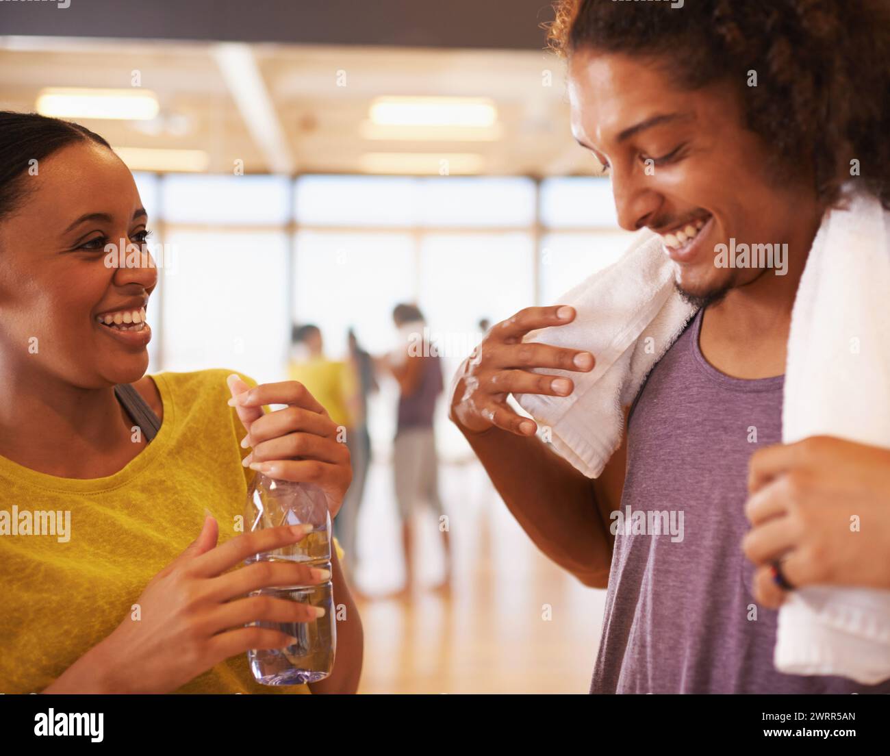 People, drinking water and hydration in dance studio, smile and relax ...