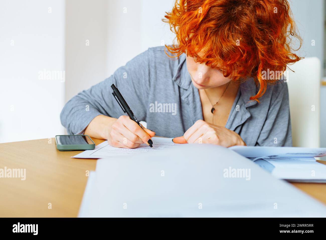 portrait attractive teenage girl filling out paper form Stock Photo - Alamy
