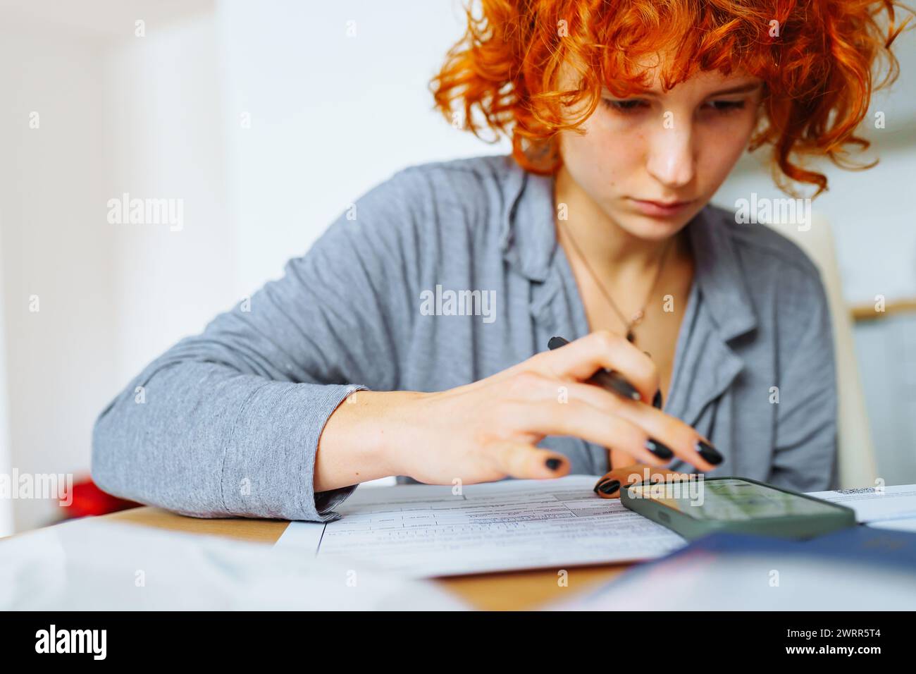 portrait attractive teenage girl filling out paper form Stock Photo - Alamy