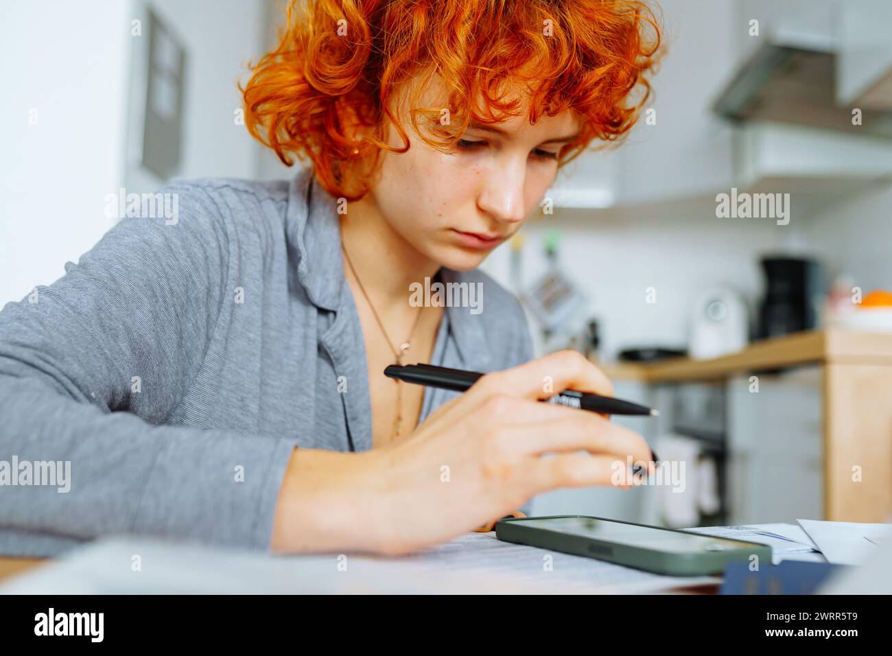 portrait attractive teenage girl filling out paper form Stock Photo - Alamy
