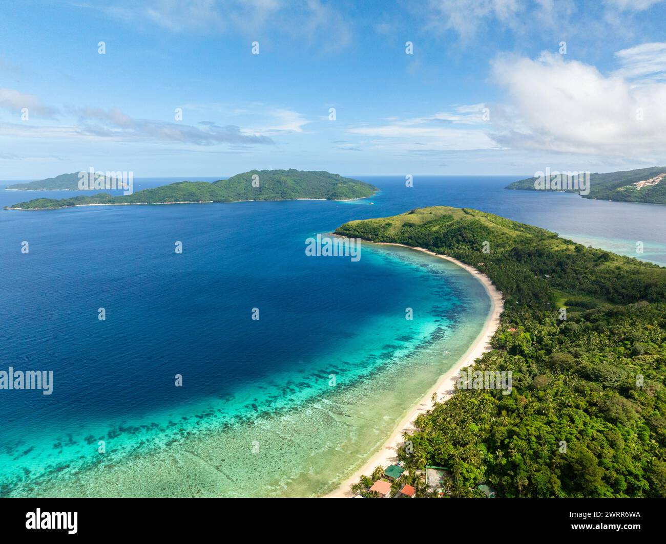 Tropical Island with beaches at coastline surrounded by blue sea ...