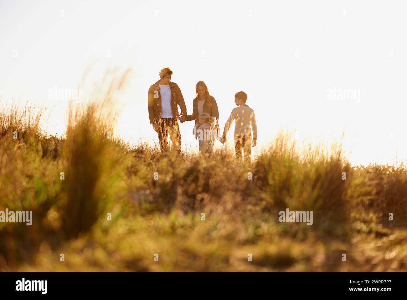 Family, grass and walk at sunset, nature and bonding with exercise for ...