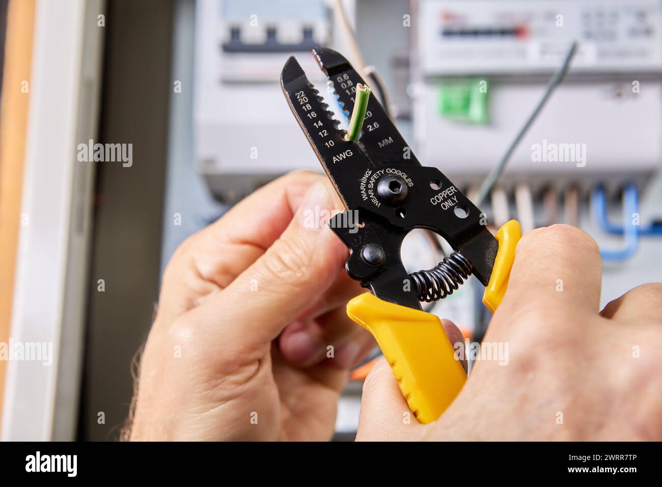 Tool for stripping wires is used when installing an outdoor electrical ...