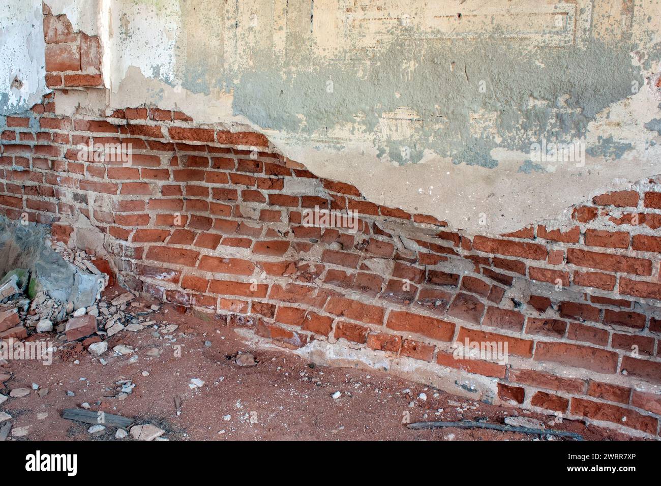 Distressed brick wall in the old destroyed abandoned building, selective focus. Weathering and ...