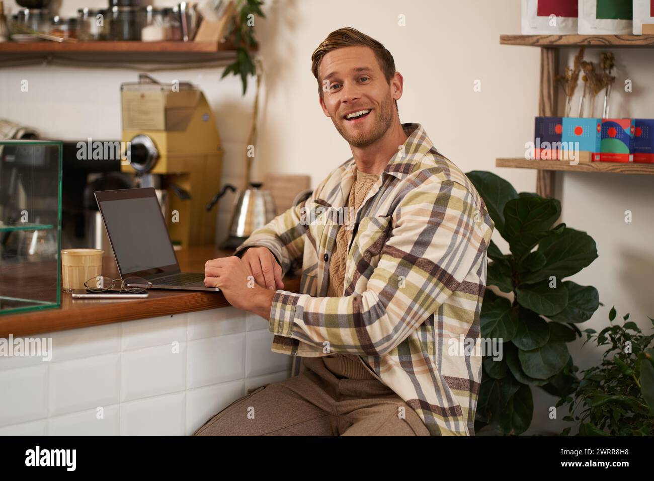 Small business concept. Handsome businessman, cafe owner, sitting near ...