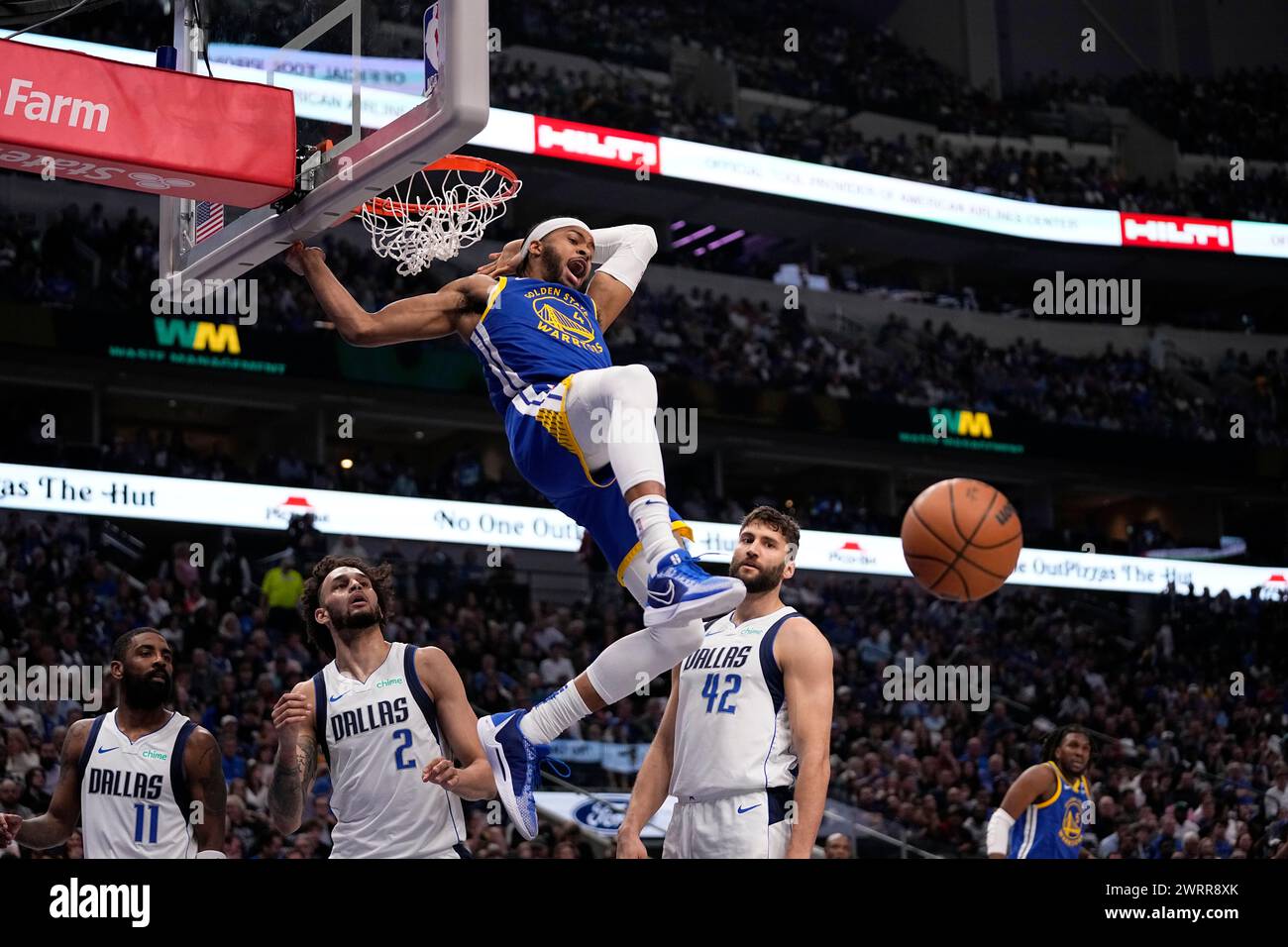 Golden State Warriors guard Moses Moody (4) dunks the ball after getting throgh Dallas Mavericks ...