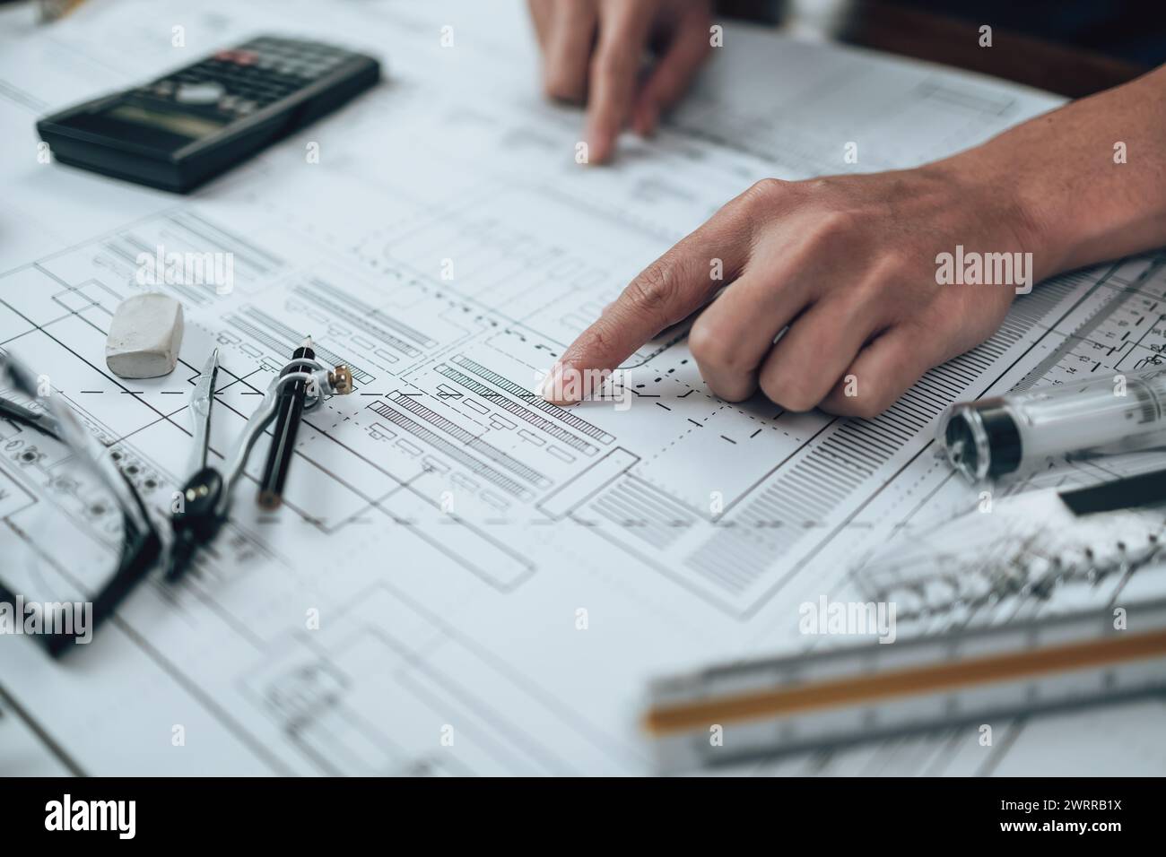 Engineering working with drawings inspection on the office desk and ...