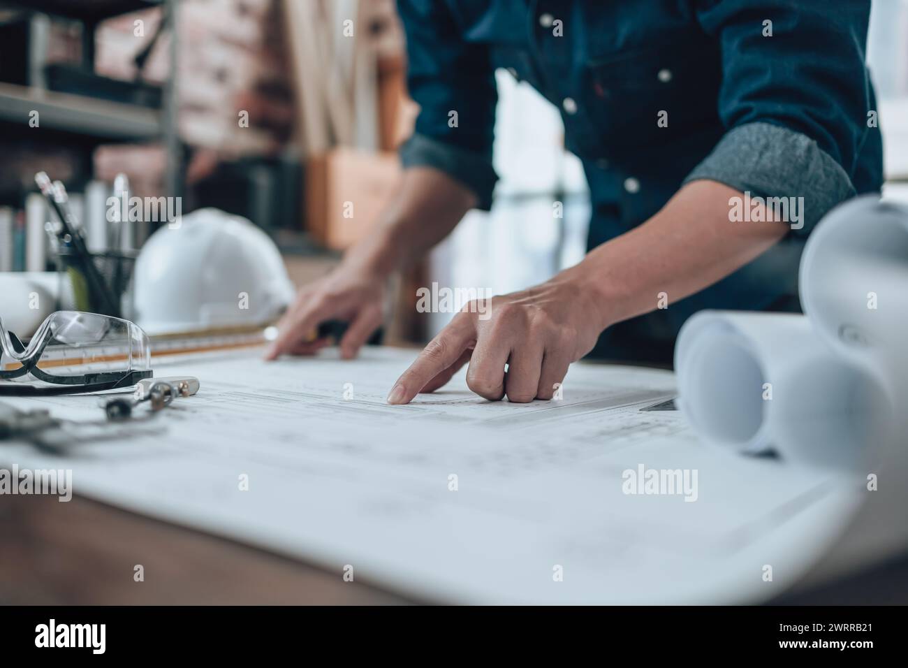 Engineering working with drawings inspection on the office desk and ...