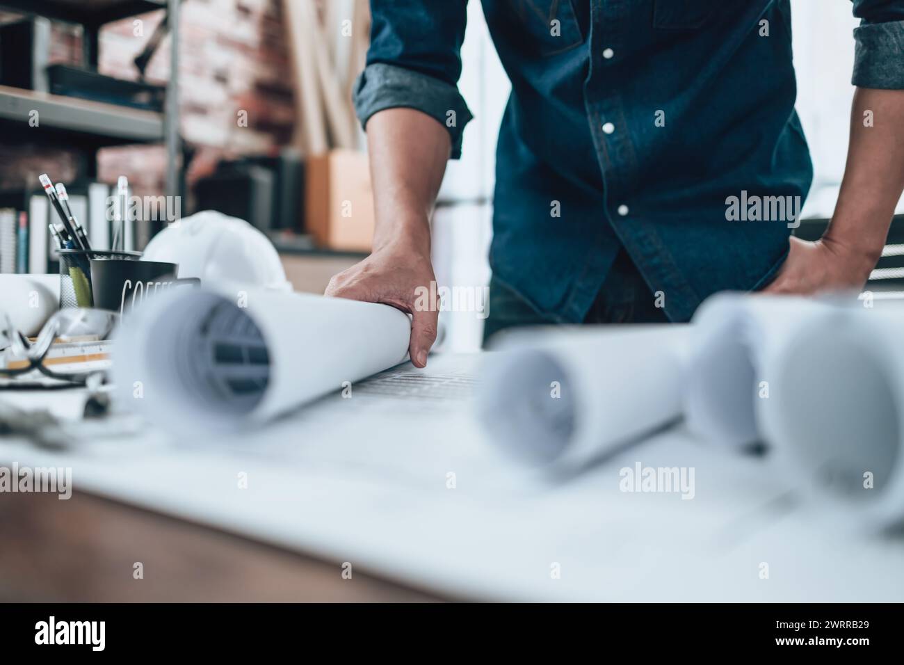Engineering working with drawings inspection on the office desk and ...