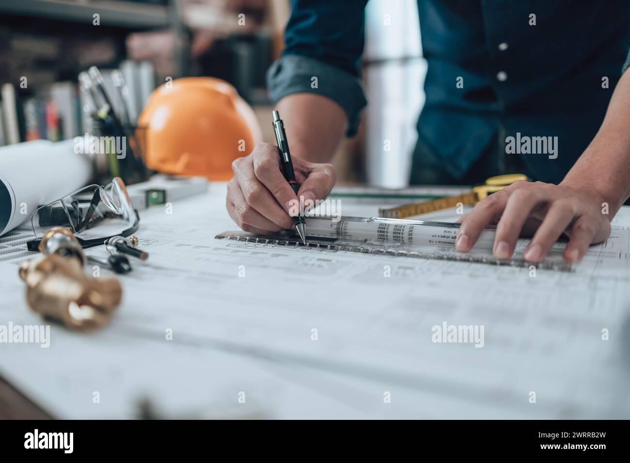 Engineering working with drawings inspection and writing on the office ...