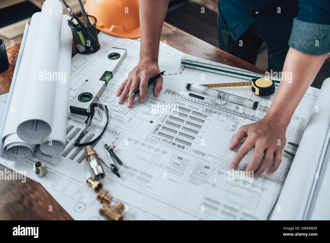 Engineering working with drawings inspection on the office desk and ...