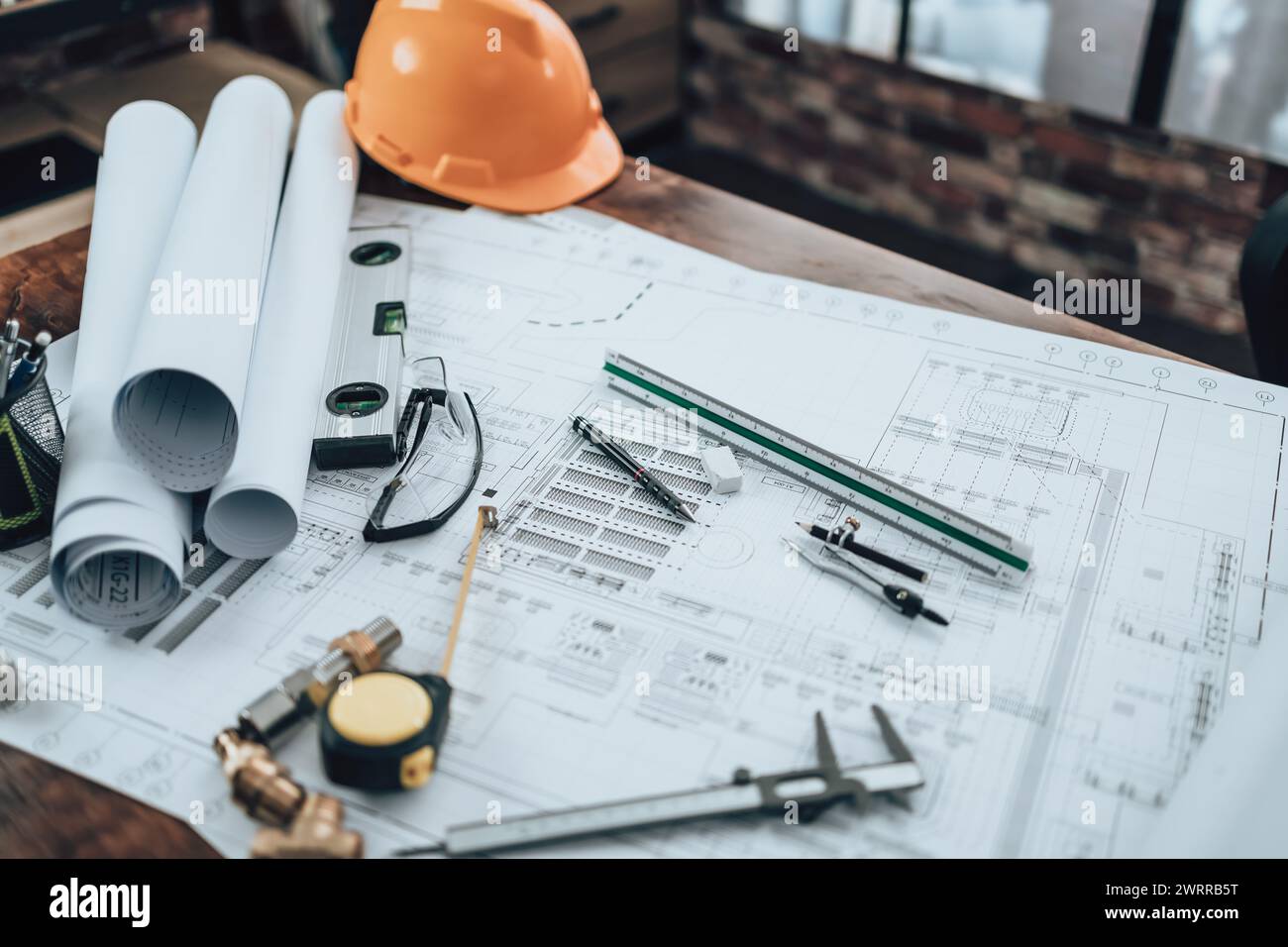 Engineering working with drawings inspection on the office desk and ...