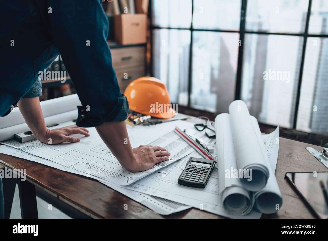 Engineering working with drawings inspection on the office desk and ...