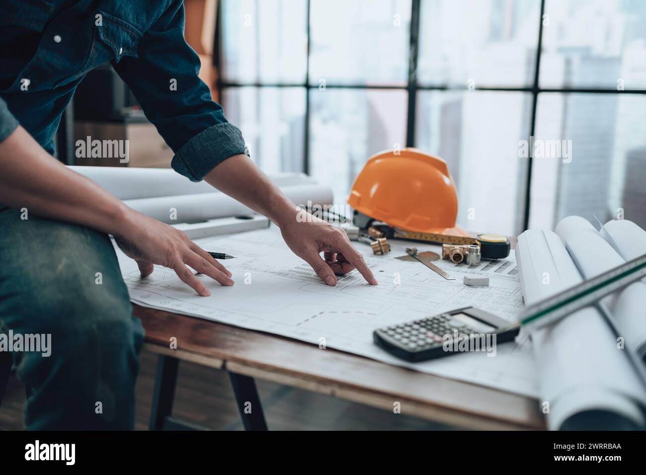 Engineering working with drawings inspection on the office desk and ...