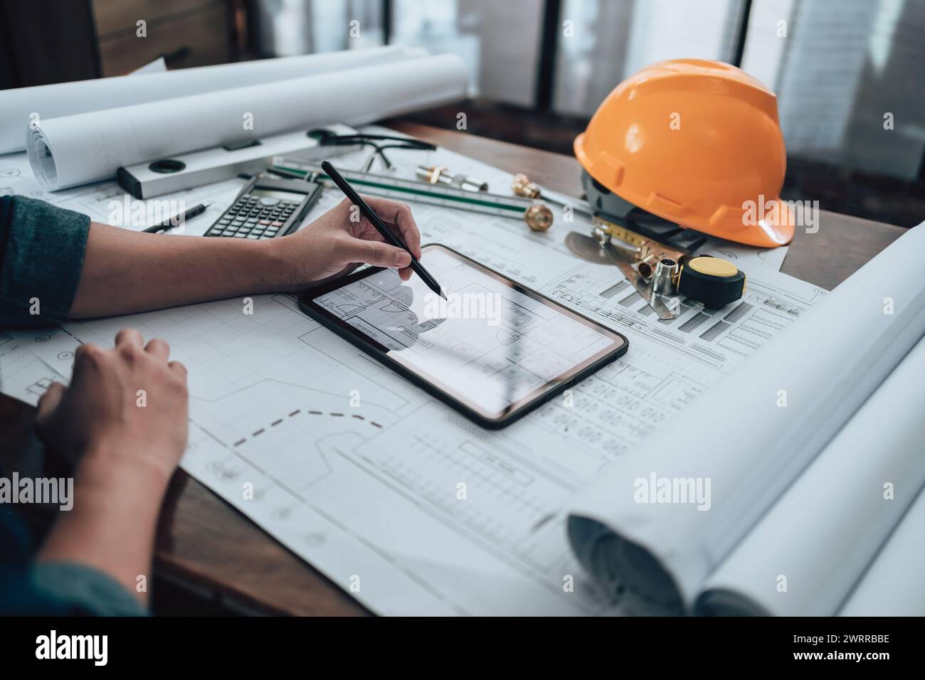 Engineering working with drawings inspection on tablet in the office ...