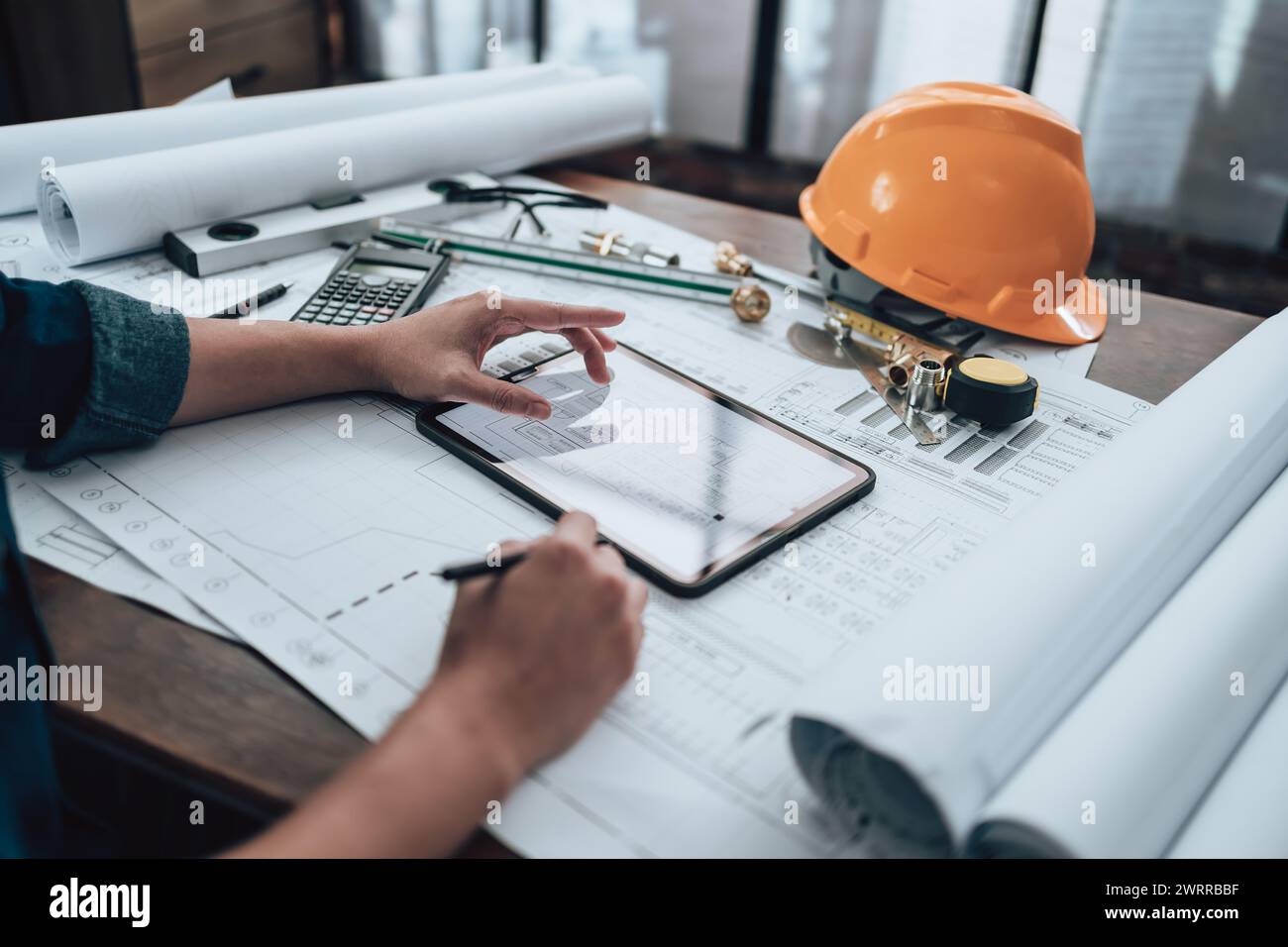 Engineering working with drawings inspection on tablet in the office ...