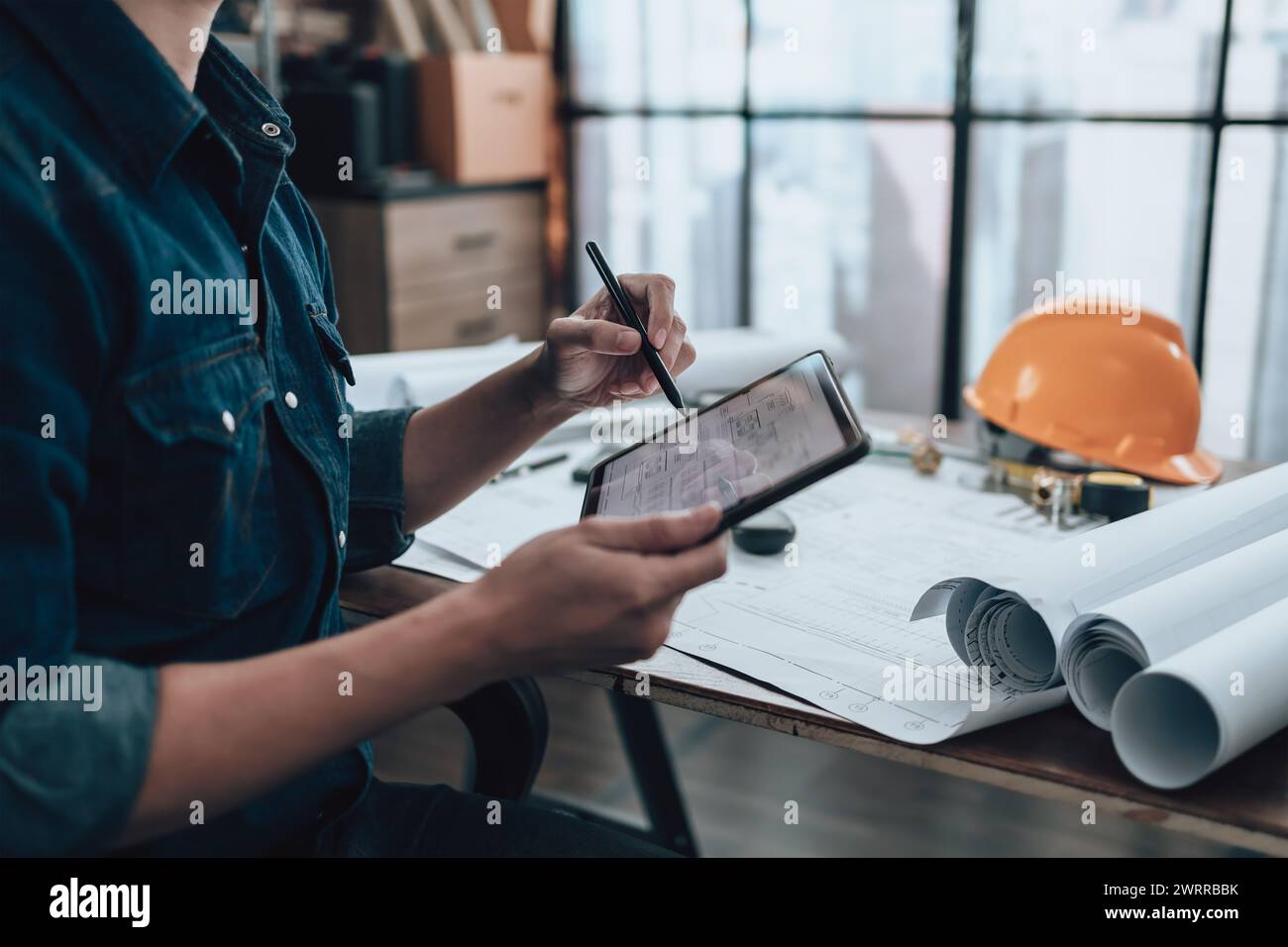 Engineering working with drawings inspection on tablet in the office ...