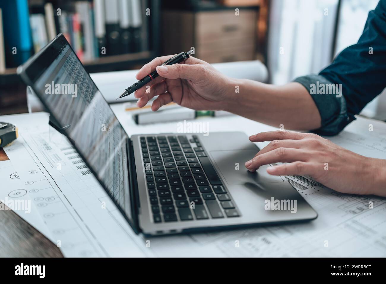 Engineering working with drawings inspection on laptop in the office ...