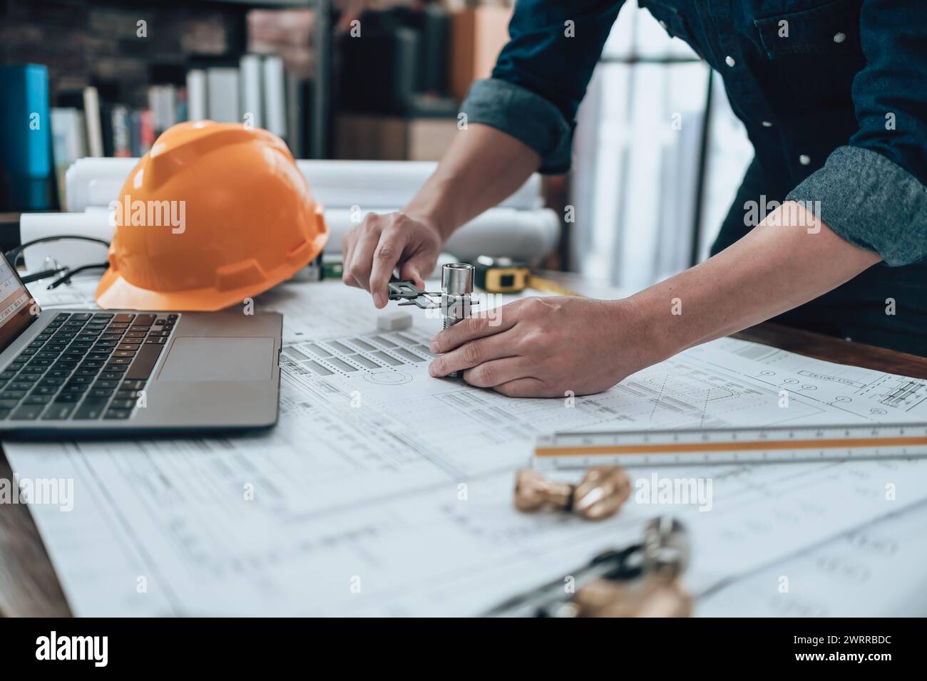 Engineering working with drawings inspection on the office desk and ...