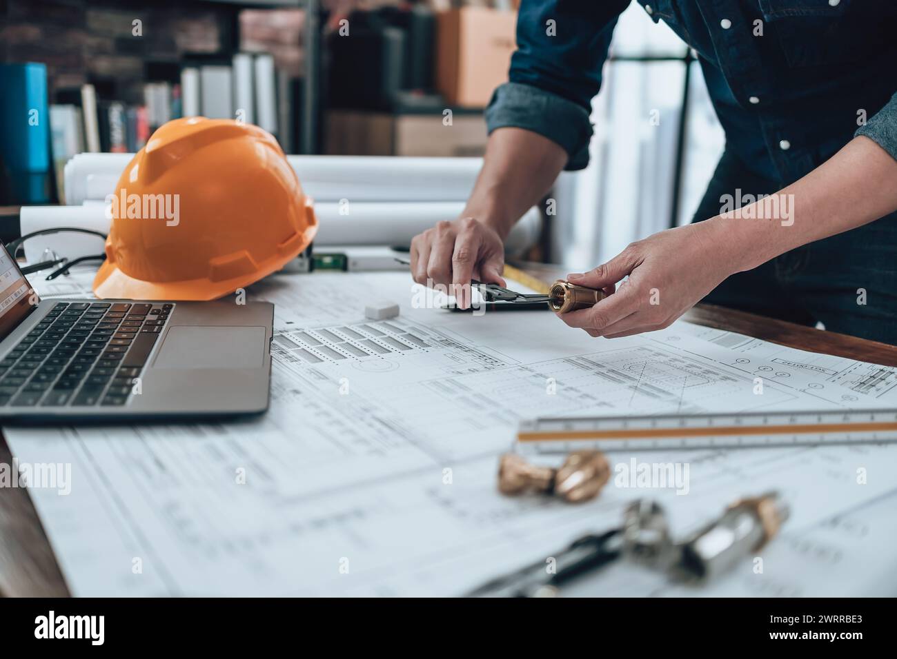 Engineering working with drawings inspection on the office desk and ...