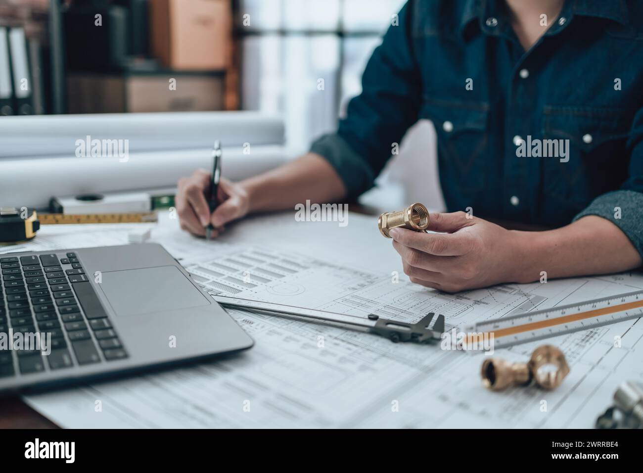 Engineering working with drawings inspection and writing on the office ...