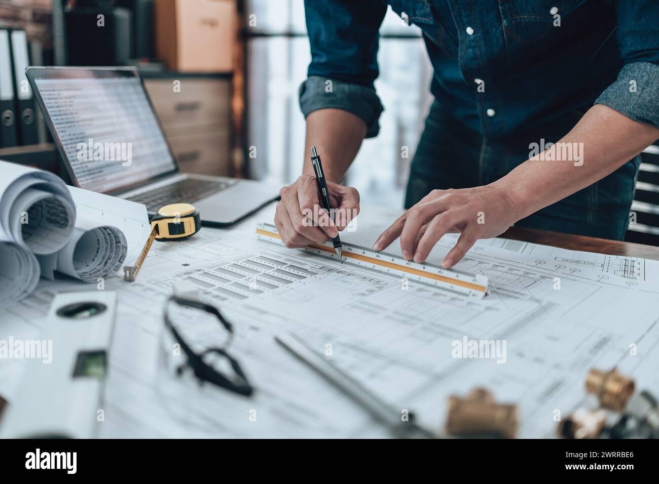 Engineering working with drawings inspection and writing on the office ...