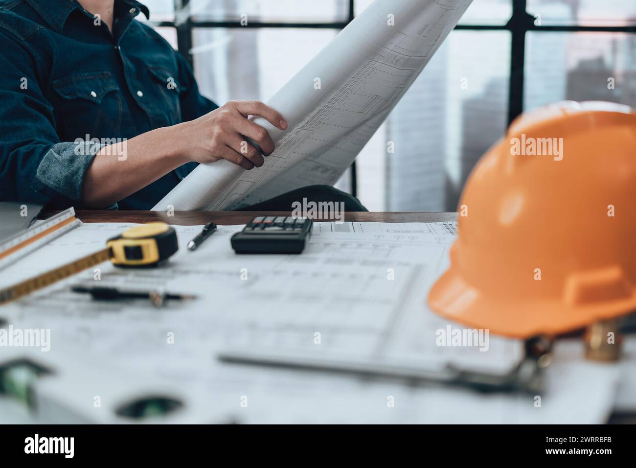 Engineering working with drawings inspection on the office desk and ...