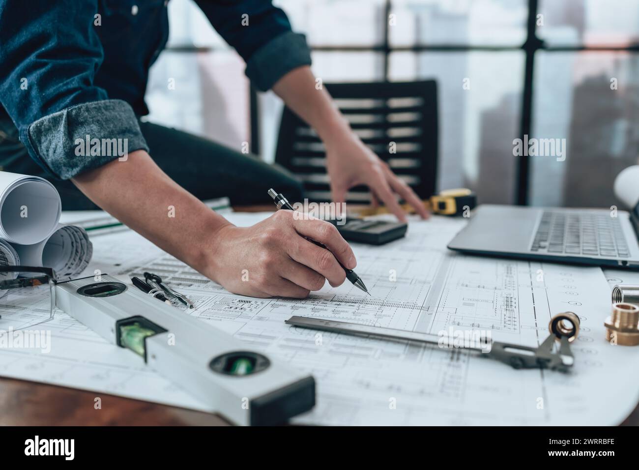Engineering working with drawings inspection and writing on the office ...
