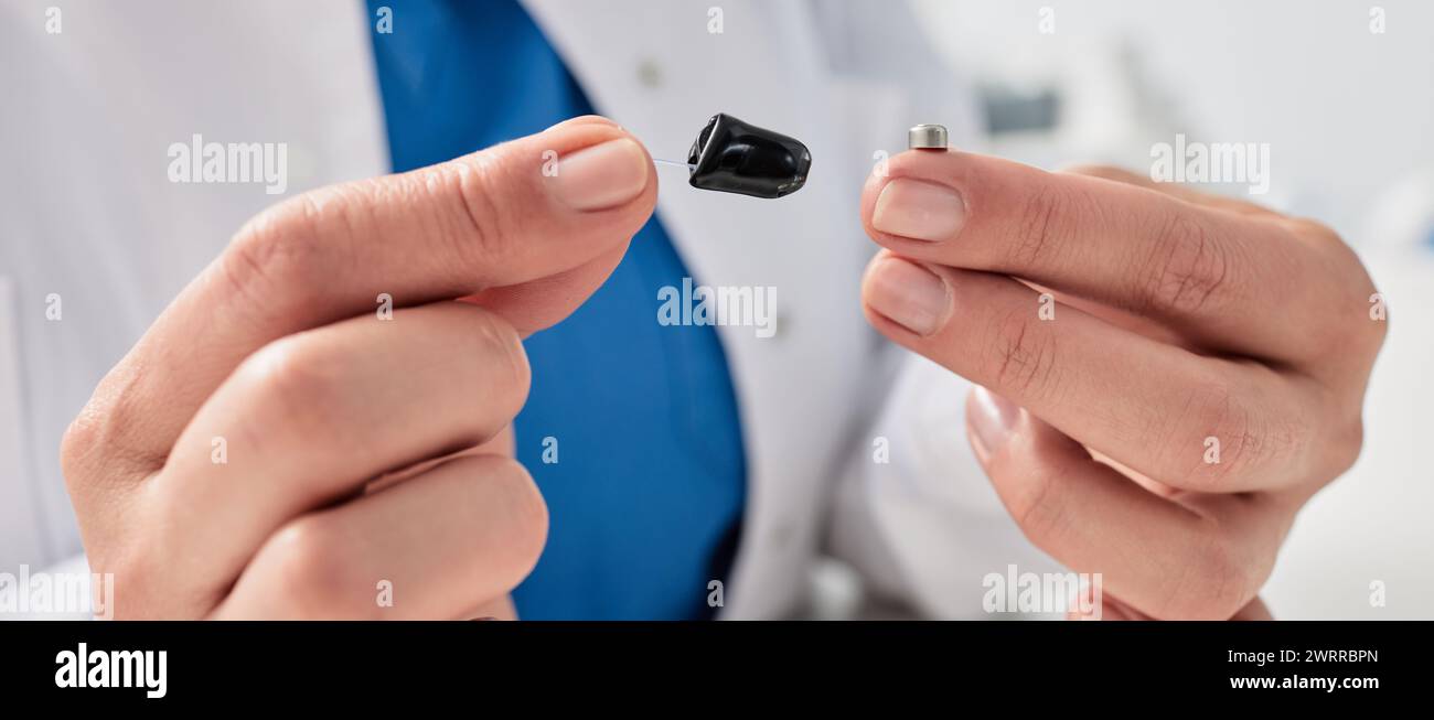 Hearing aid battery replacement. Audiologist showing ITC hearing aid ...