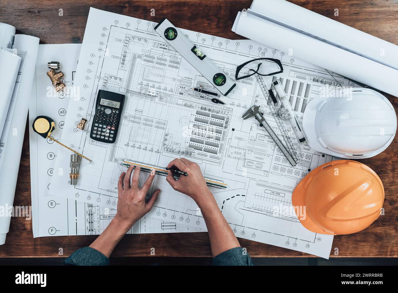 Top view Engineering working with drawings inspection and writing on ...