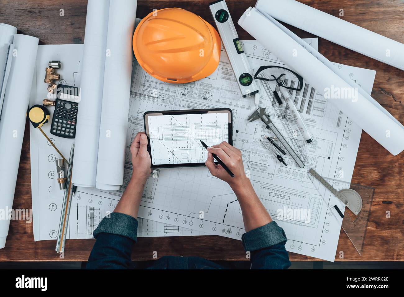 Engineering working with drawings inspection on tablet in the office ...