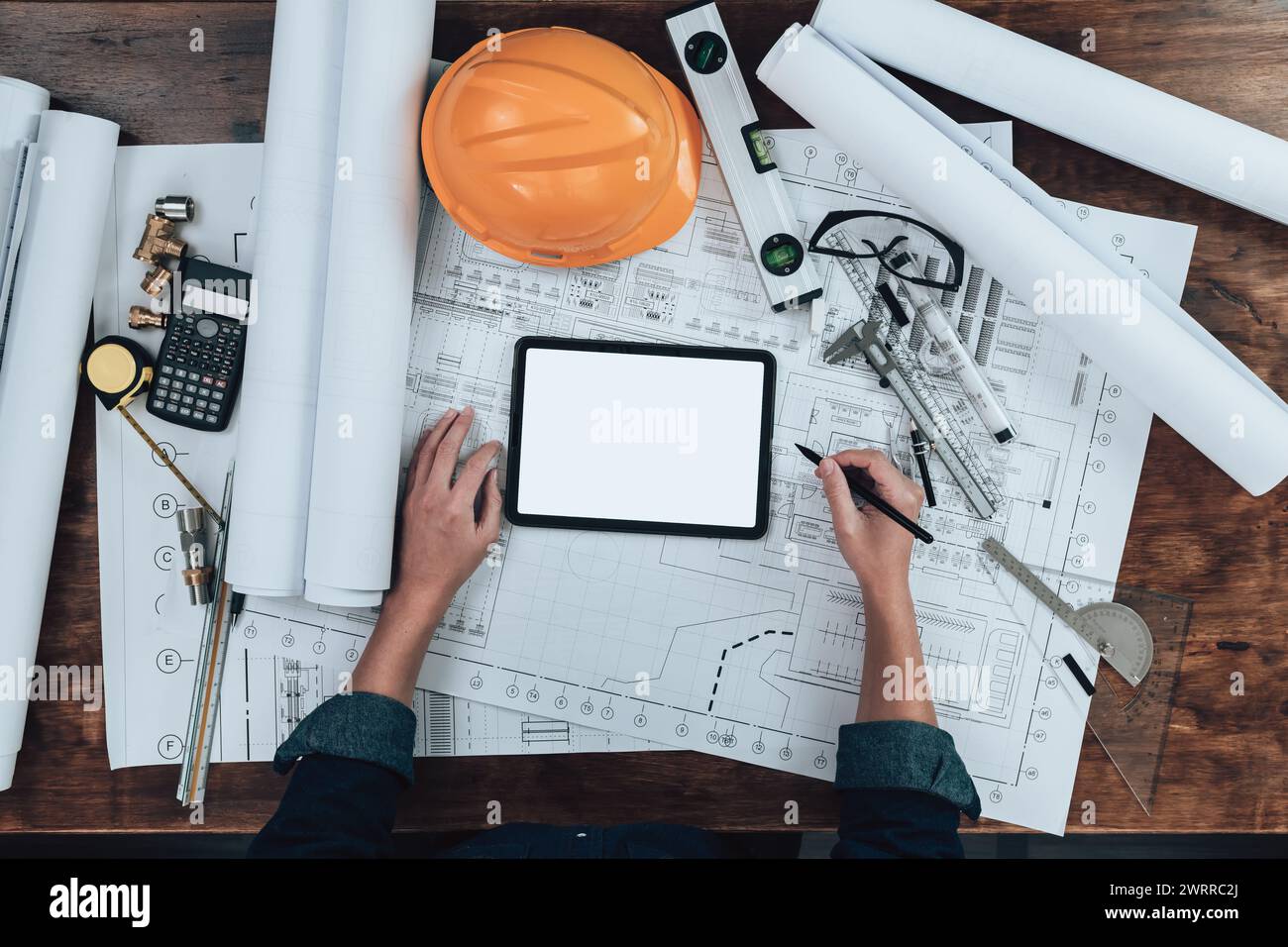 Engineering working with drawings inspection on tablet in the office ...