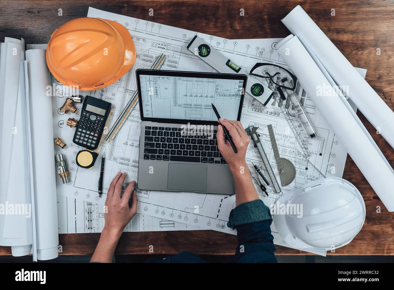 Engineering working with drawings inspection on laptop in the office ...