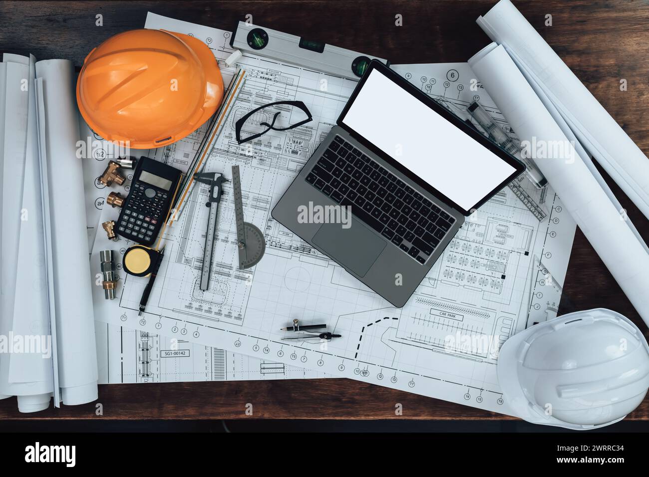 Laptop with drawings inspection on the office desk and Calculator ...