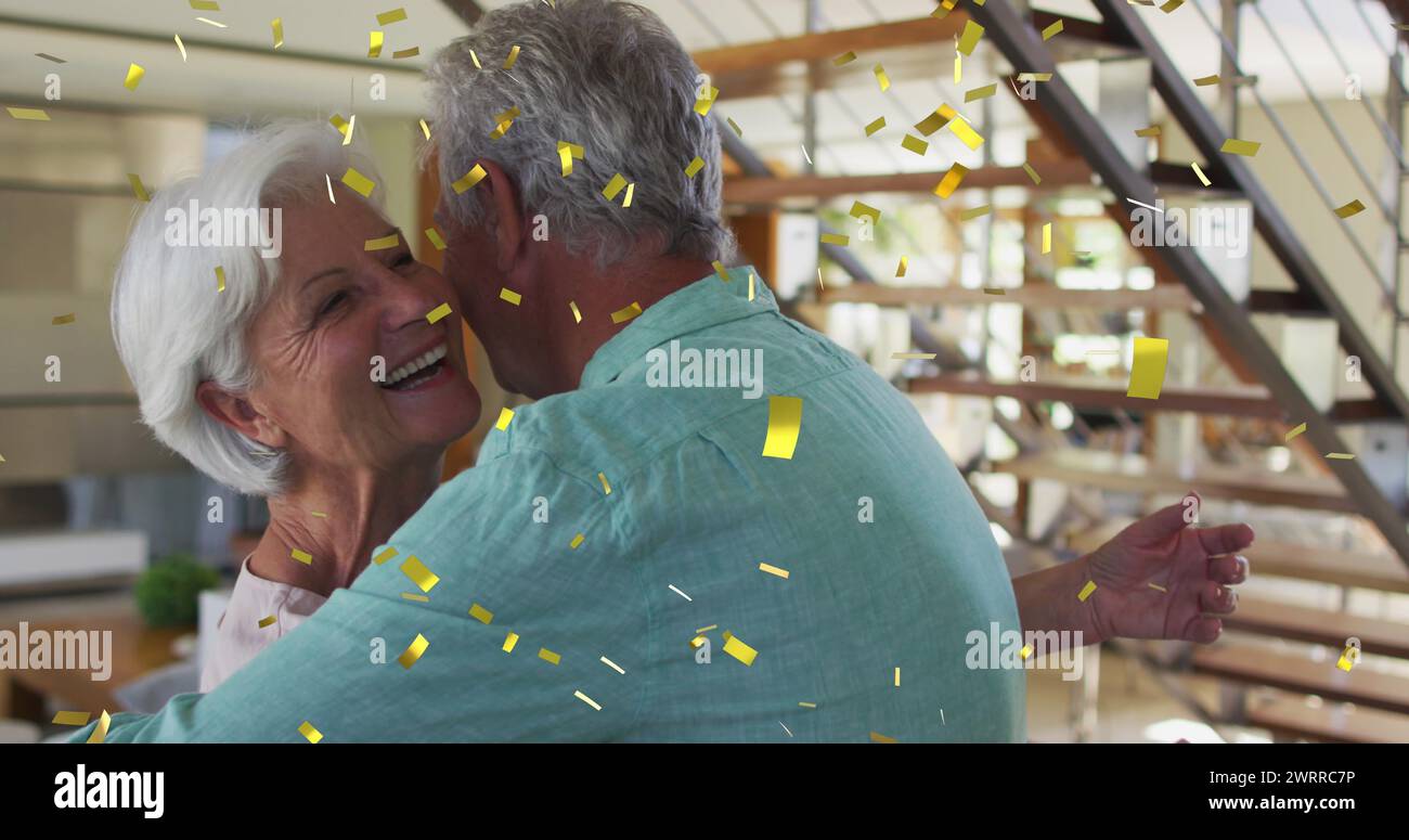Image of gold confetti falling over happy caucasian senior couple ...