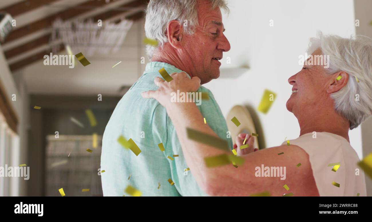 Image of gold confetti falling over happy caucasian senior couple ...