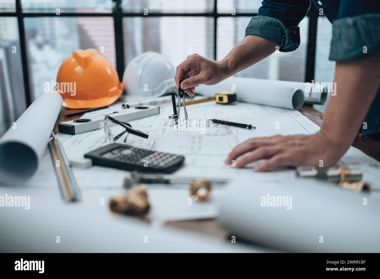 Engineering working with drawings inspection and writing on the office ...