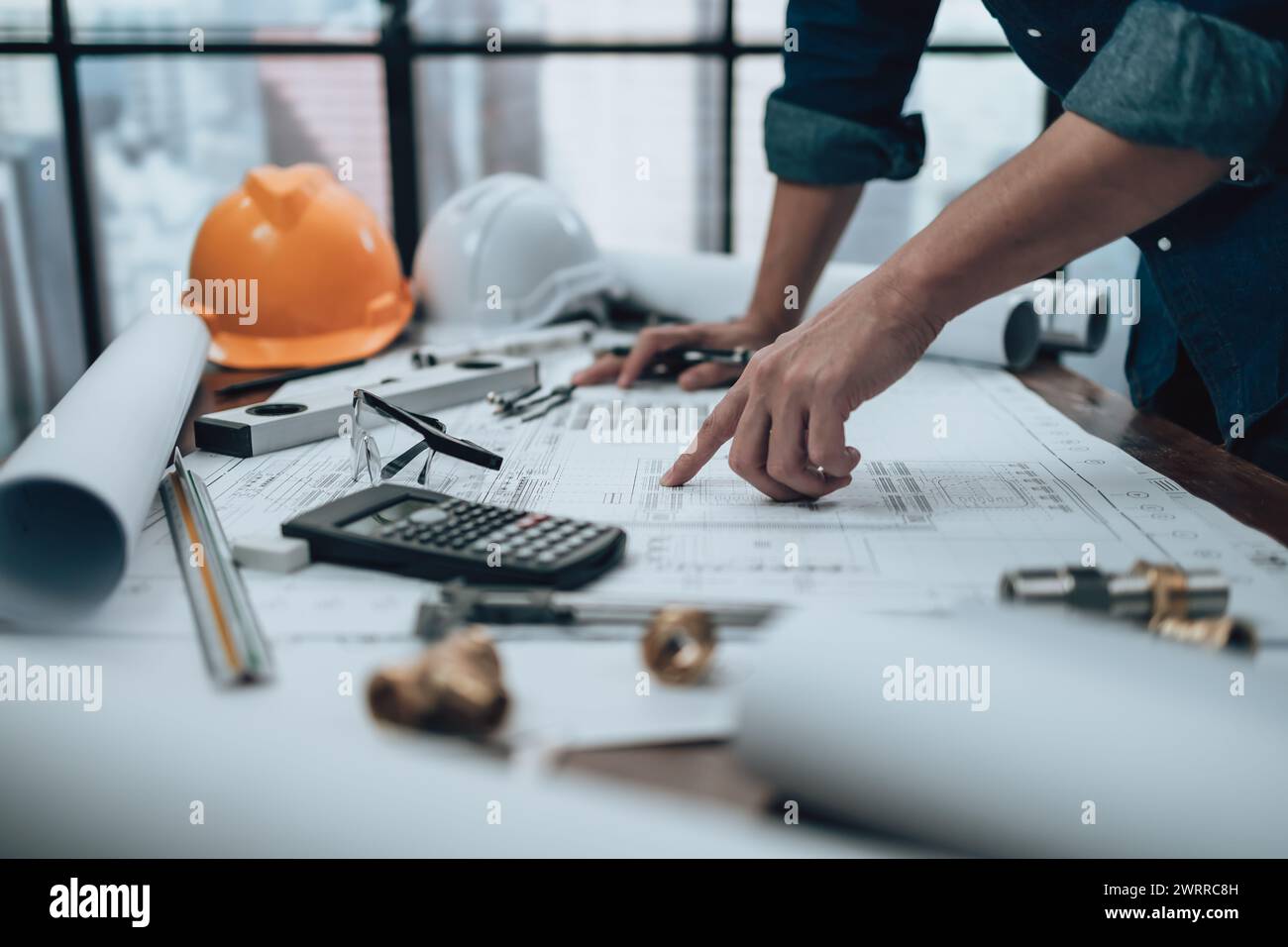 Engineering working with drawings inspection on the office desk and ...