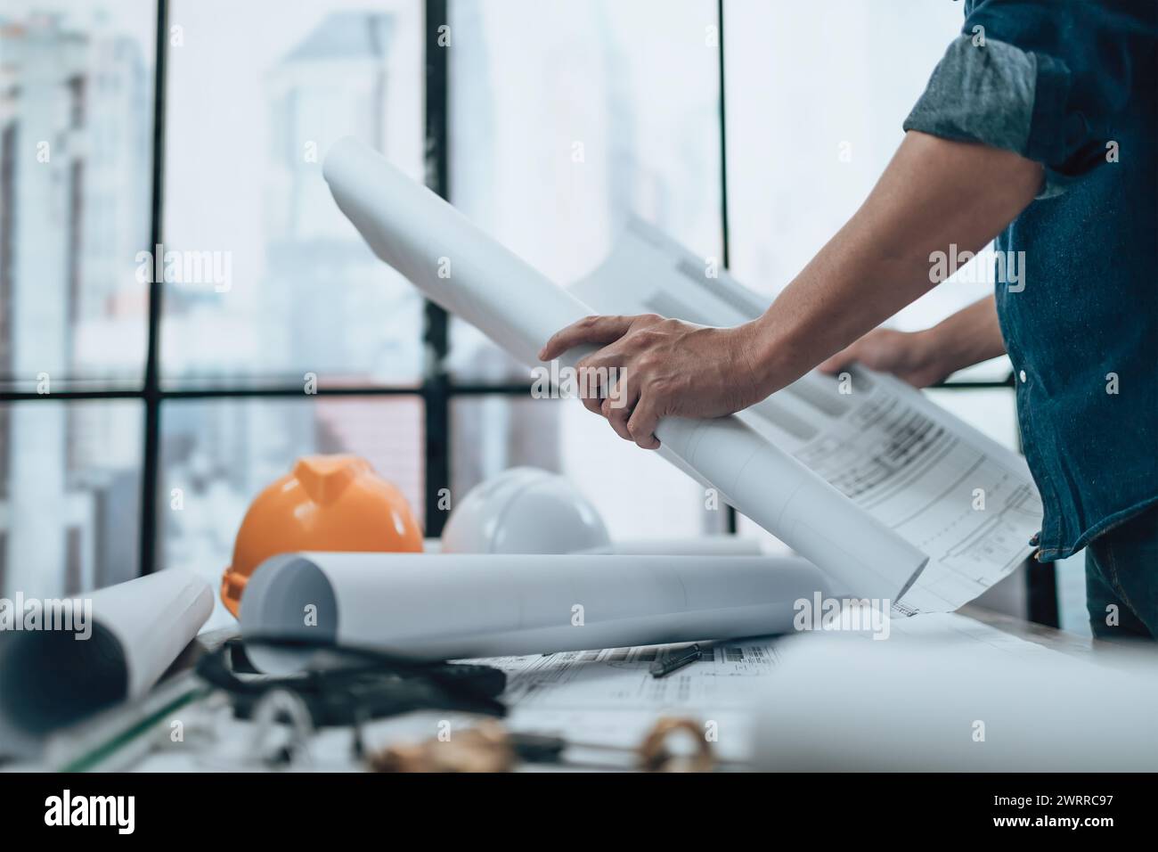 Engineering working with drawings inspection on the office desk and ...