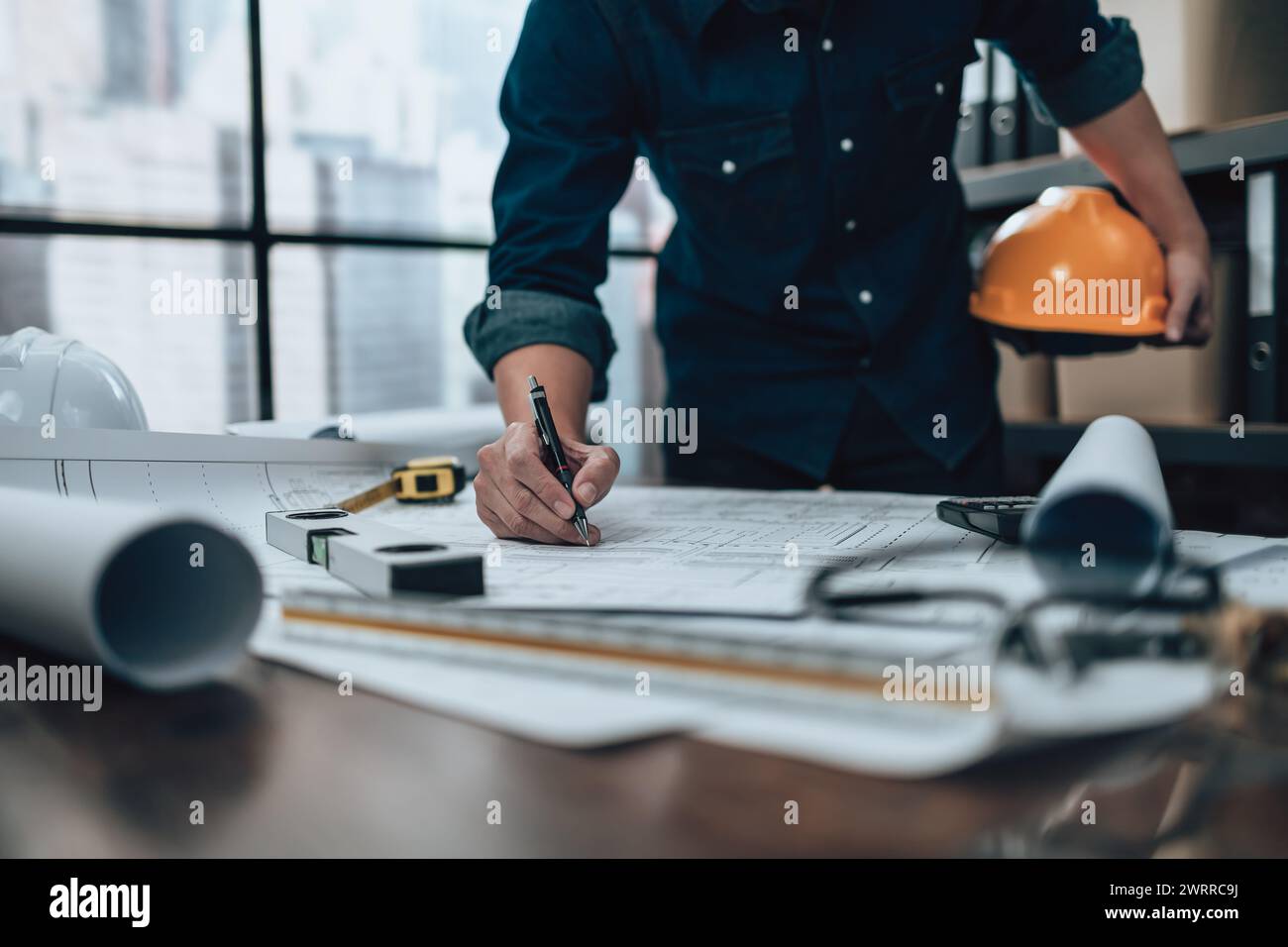 Engineering working with drawings inspection on the office desk and ...