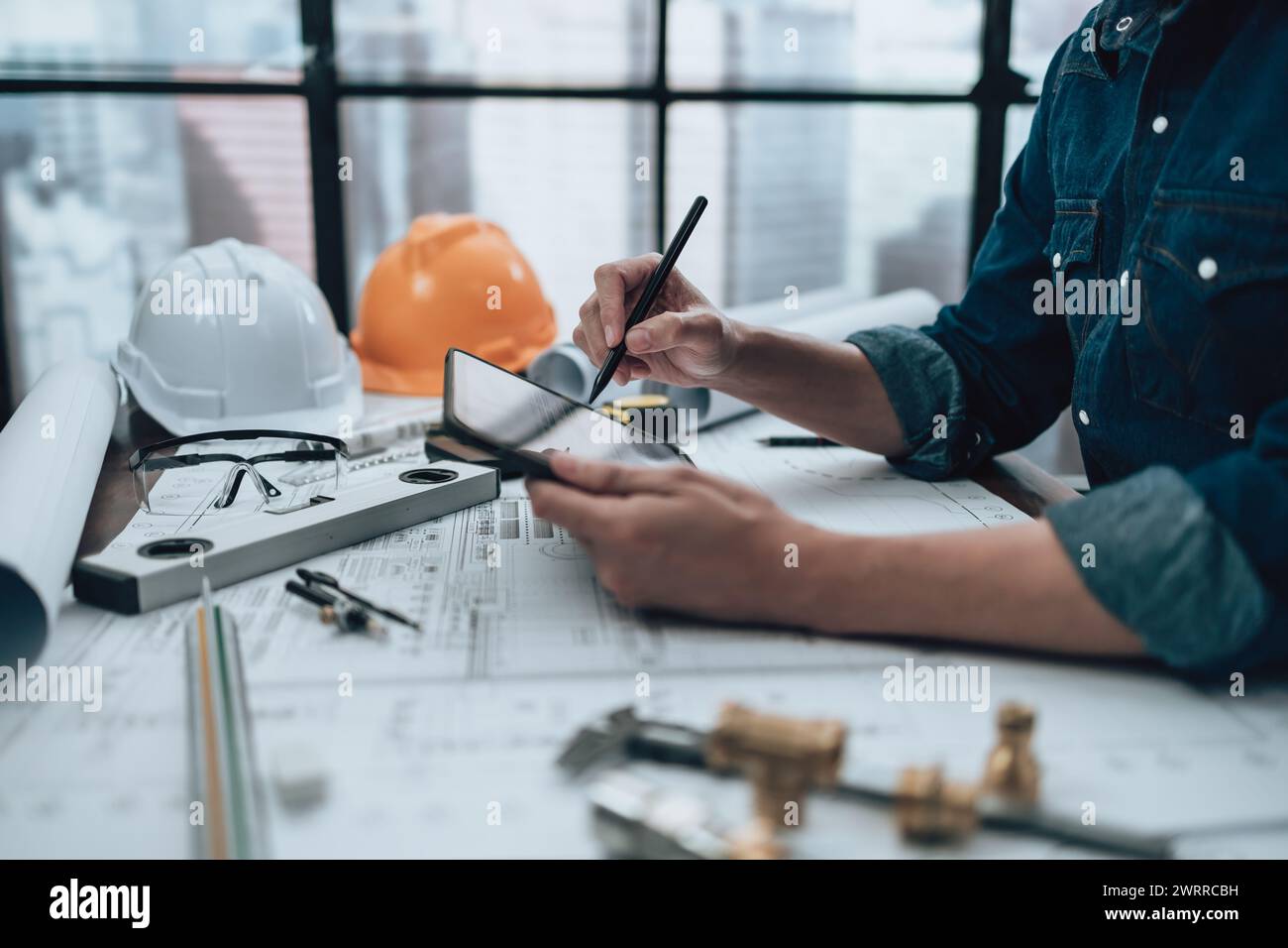 Engineering working with drawings inspection on tablet in the office ...