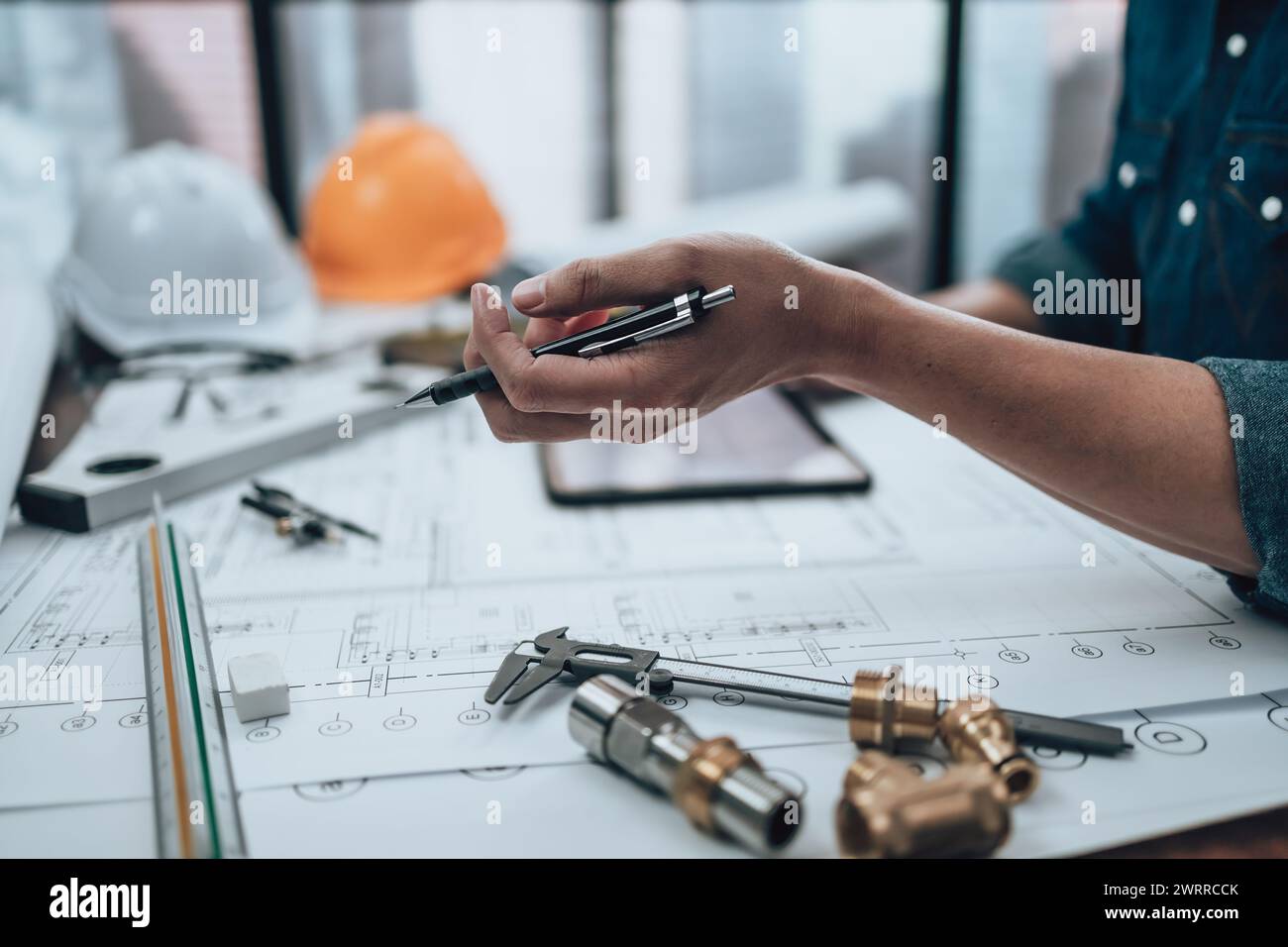 Engineering working with drawings inspection on the office desk and ...